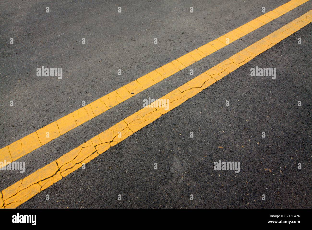yellow double solid line on the road Stock Photo - Alamy