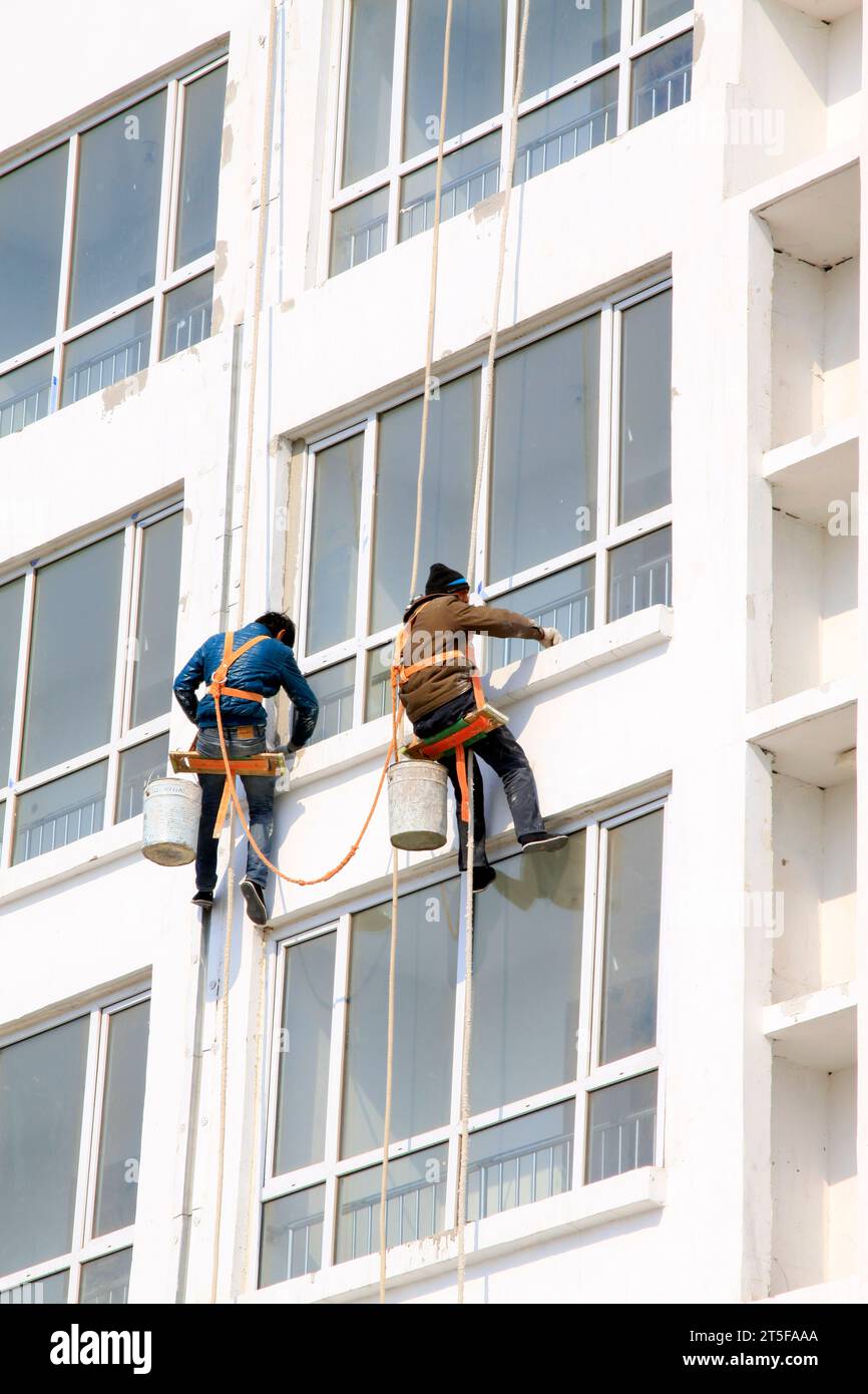 painter in high rise buildings, north china Stock Photo - Alamy