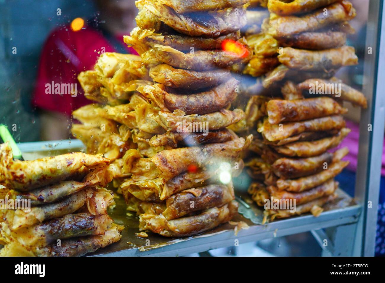 Fried chocolate banana cakes are arranged in a glass street food ...