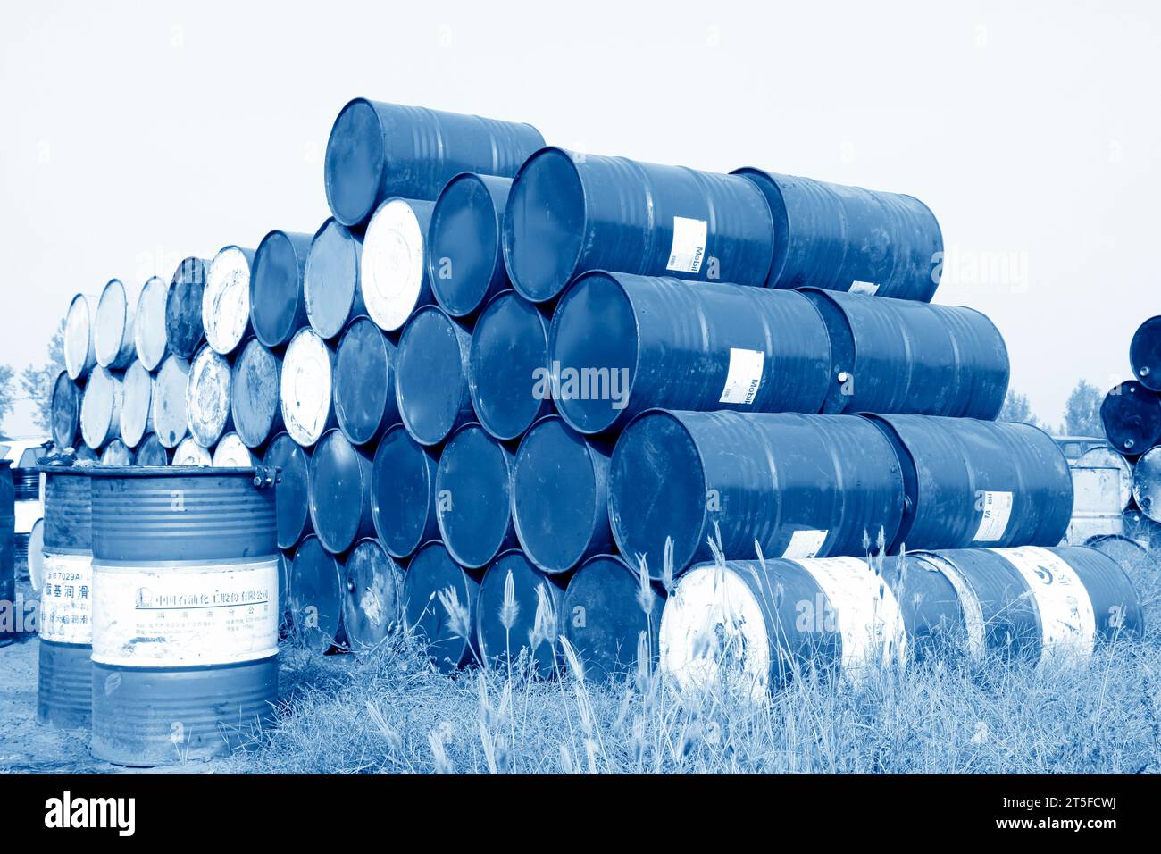 oil drums stacked together in a yard, north china Stock Photo - Alamy