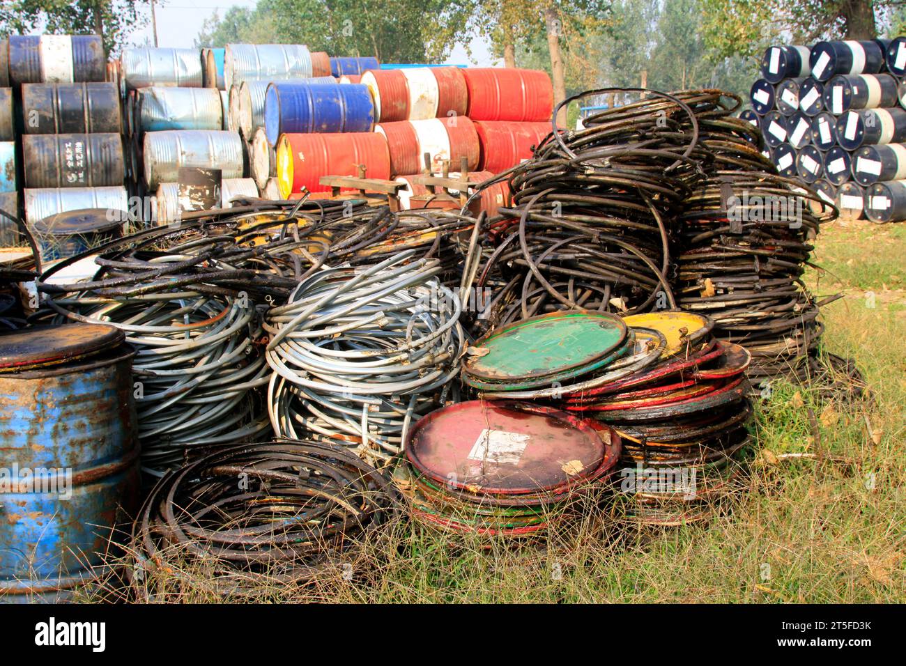 oil drum parts piled up together in a storage area Stock Photo - Alamy