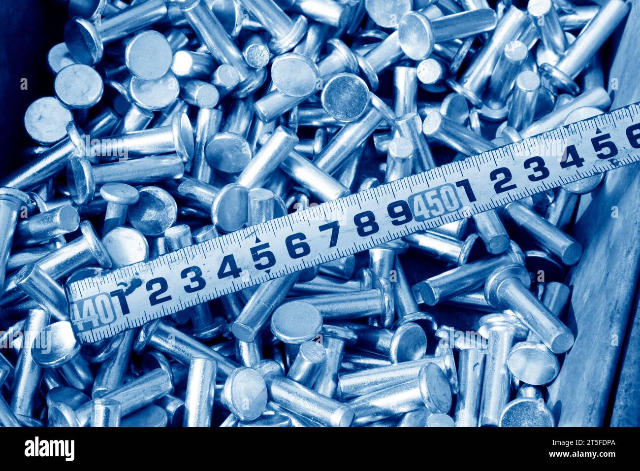 new rivet and tape measure piled up together Stock Photo - Alamy