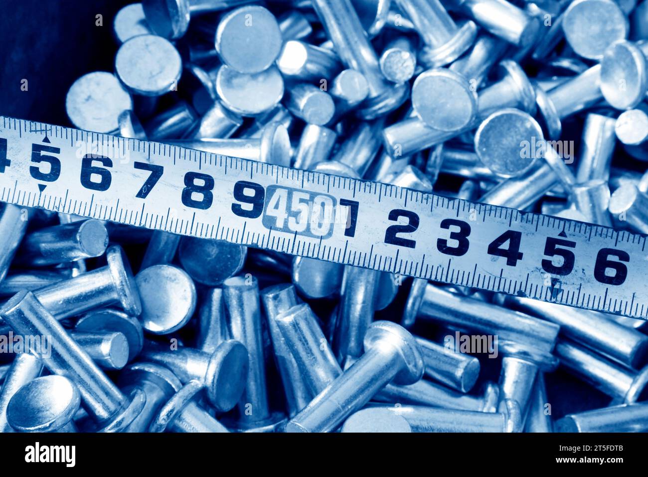 new rivet and tape measure piled up together Stock Photo - Alamy