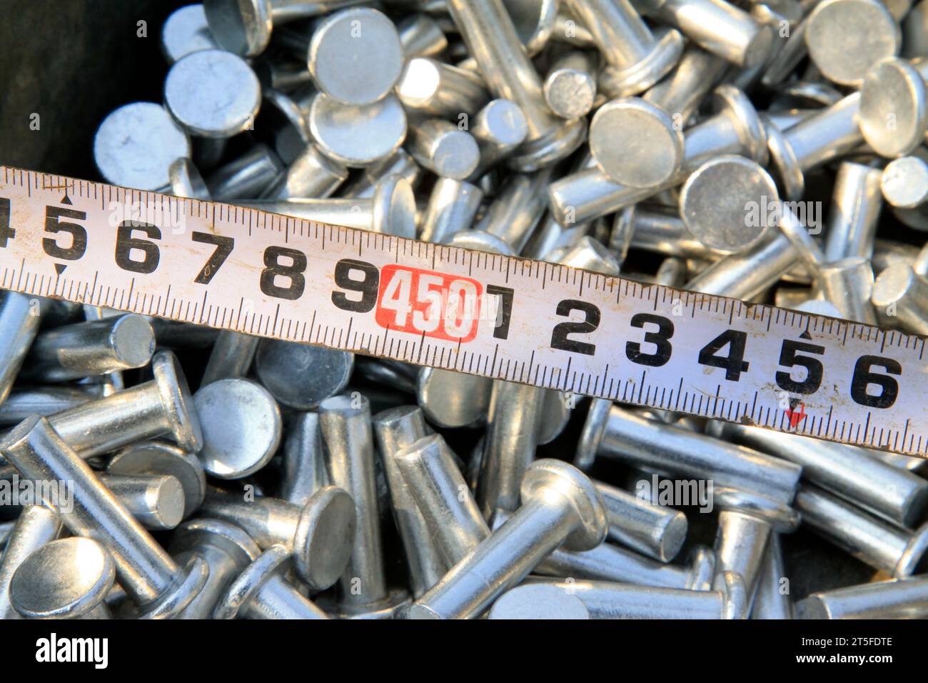 new rivet and tape measure piled up together Stock Photo - Alamy