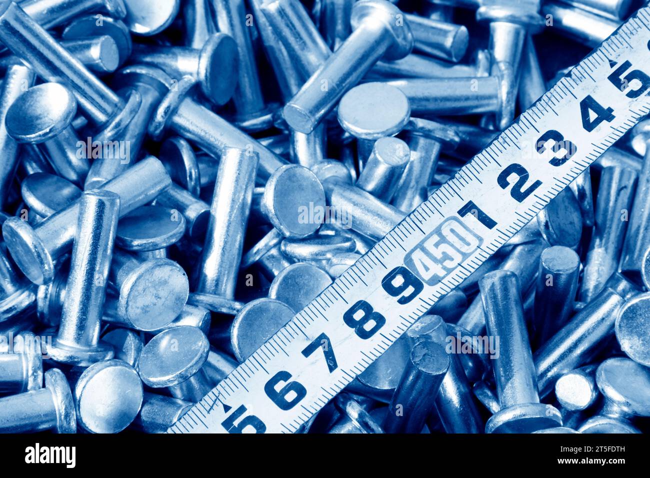 new rivet and tape measure piled up together Stock Photo - Alamy