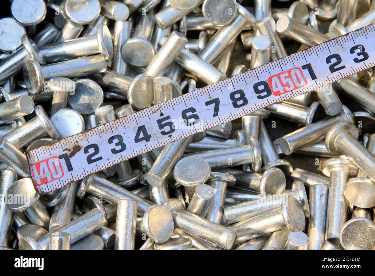 new rivet and tape measure piled up together Stock Photo - Alamy