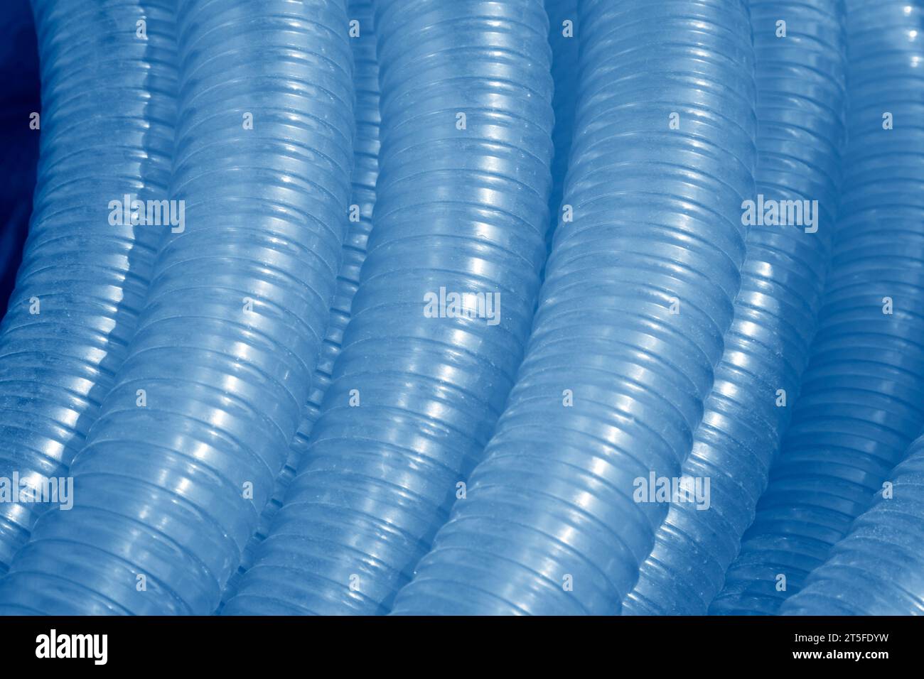 blue plastic pipe stacked toghter at a construction site Stock Photo ...