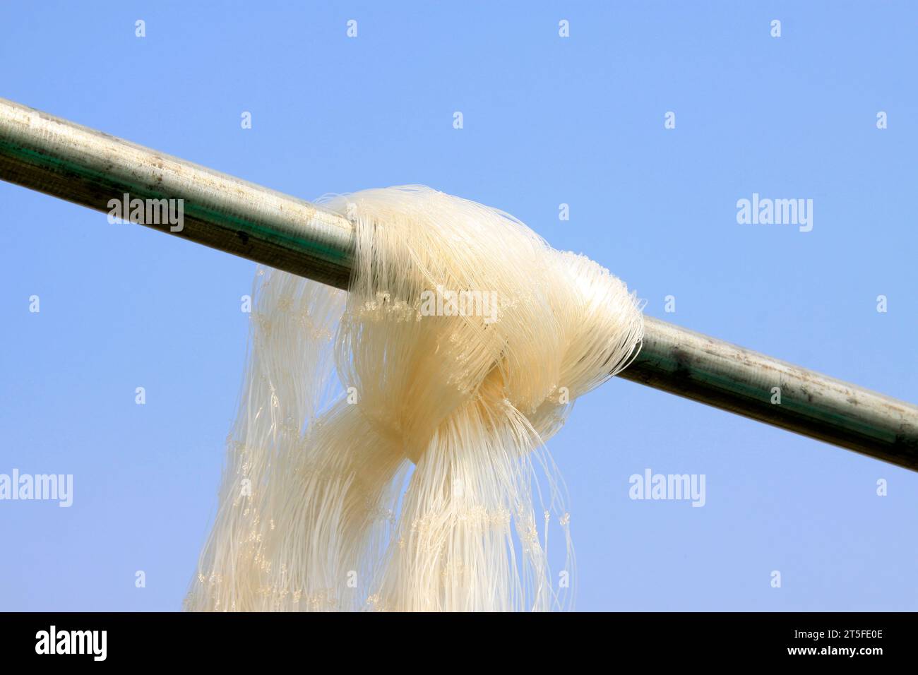 Nylon fishing nets hanging on iron rod, closeup of photo Stock Photo ...