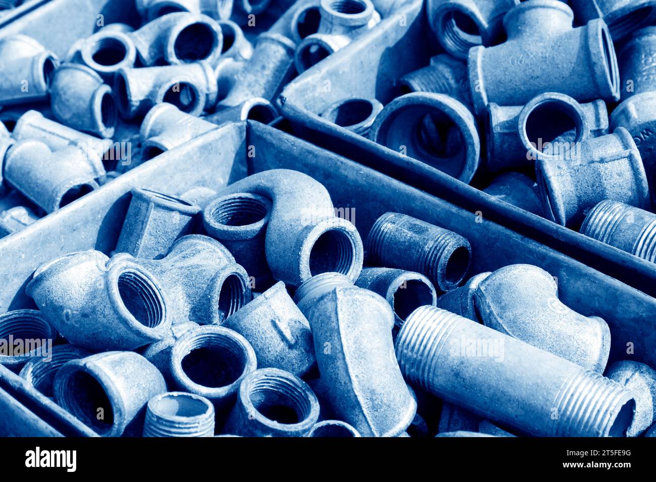 Metal plumbing pipe fittings piled up in the box in a market Stock ...