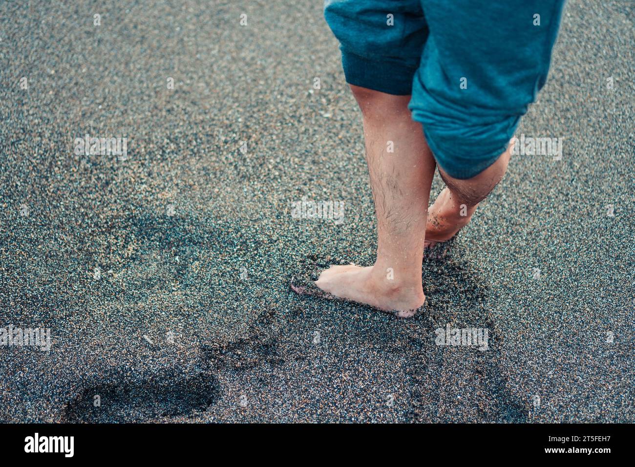 A man's feet stand on the beach sand. With copy space for text Stock ...