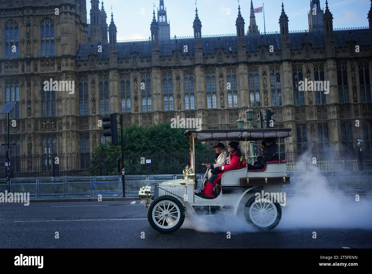Participants drive past the Palace of Westminster and over Westminster ...