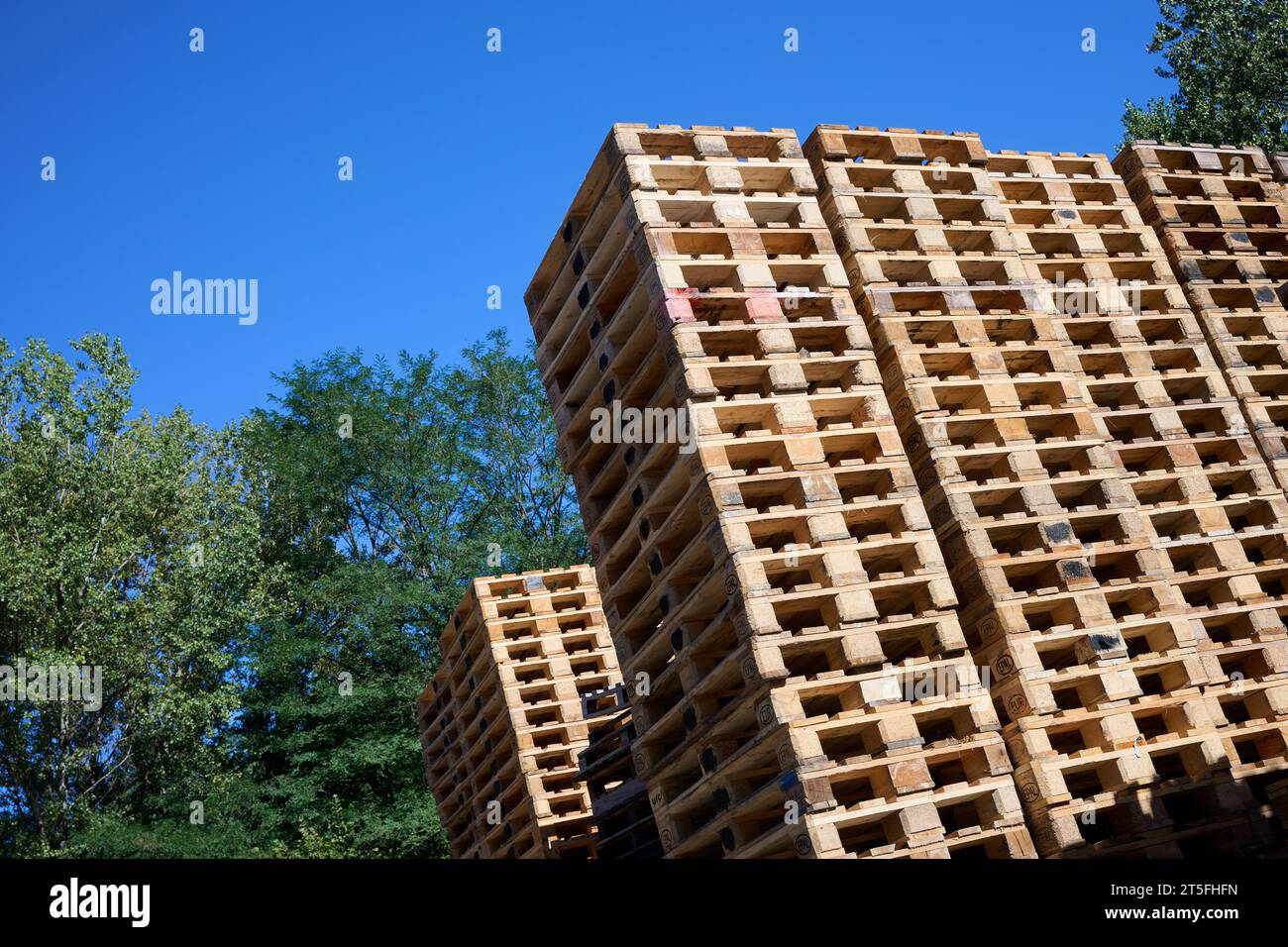 Wooden pallets stacked ready to be used Stock Photo - Alamy