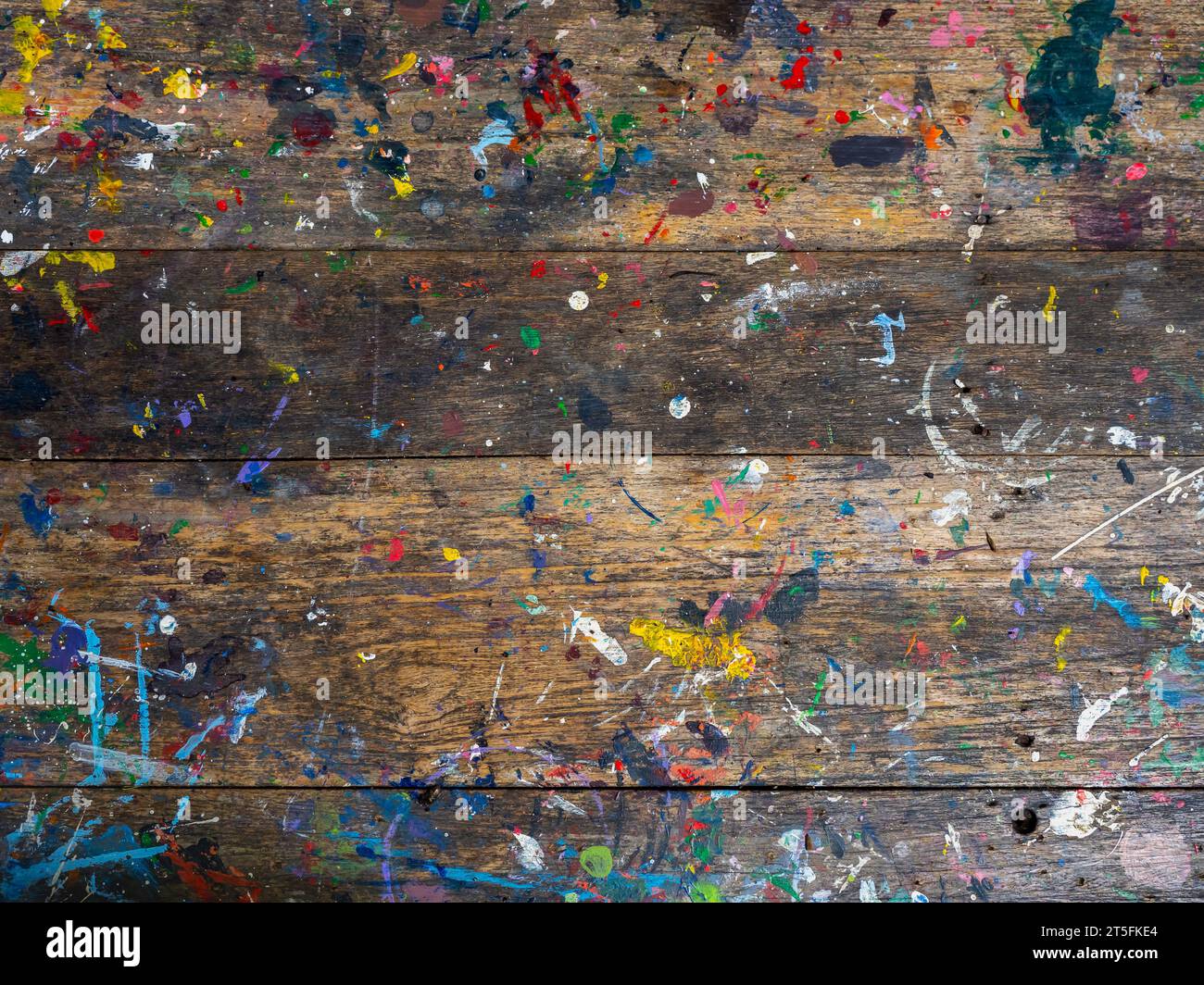 Wood plank top table covered in oil or acrylic color paint splatter ...