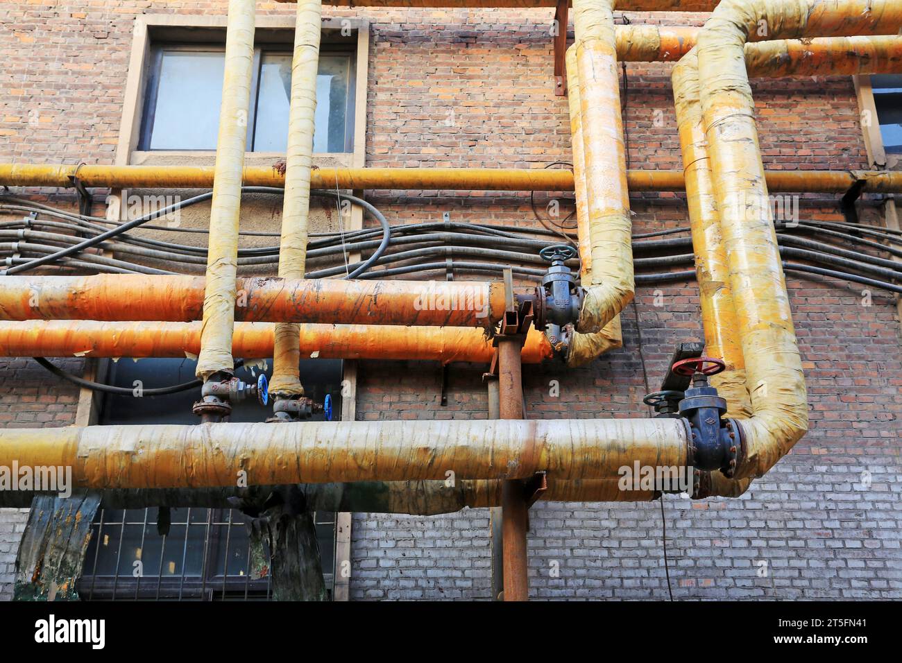 material pipe wrapped in thermal insulation in a factory Stock Photo ...