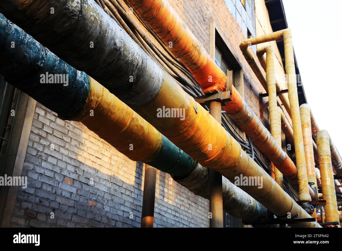 material pipe wrapped in thermal insulation in a factory Stock Photo ...