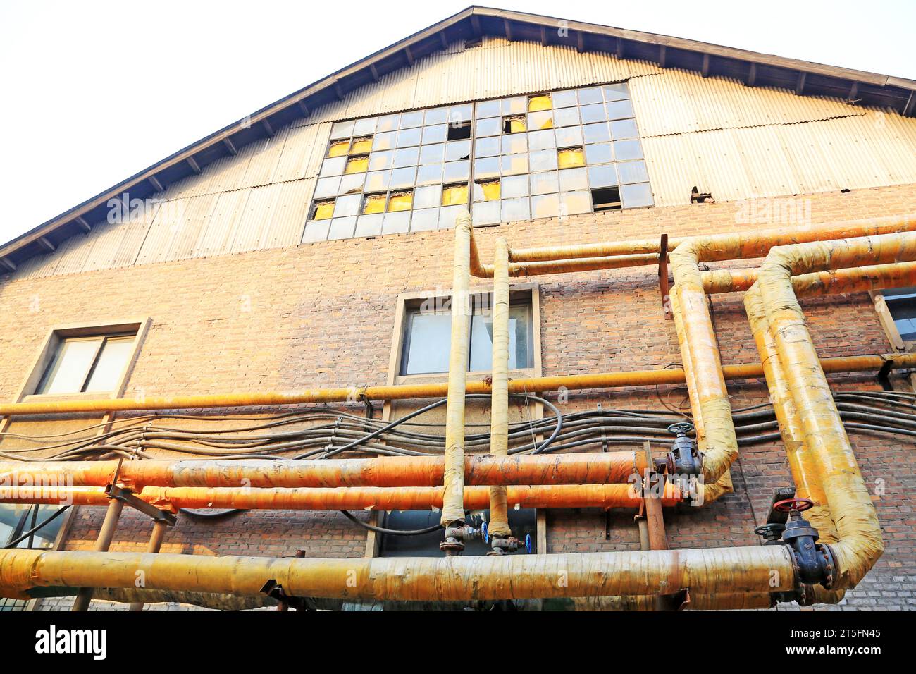 material pipe wrapped in thermal insulation in a factory Stock Photo ...