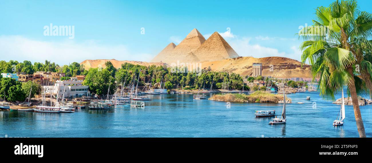 River Nile and boats at sunset in Aswan and pyramids Stock Photo - Alamy
