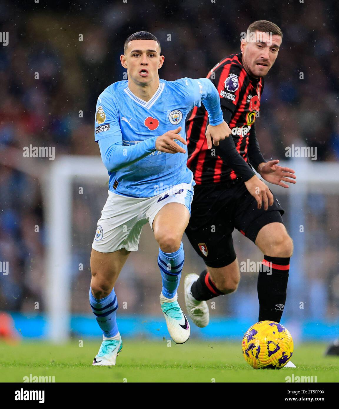 Phil Foden #47 of Manchester City runs with the ball under pressure ...