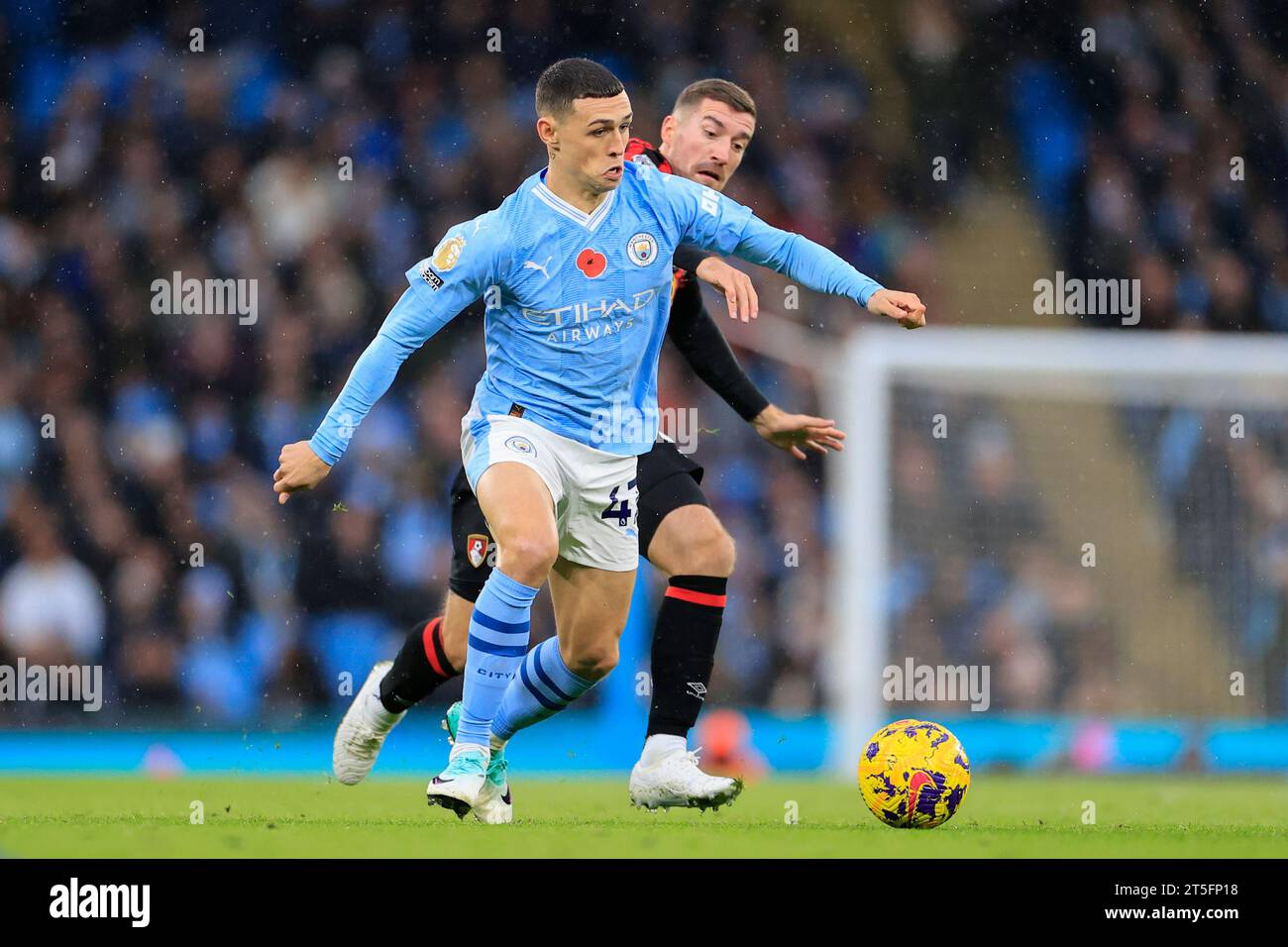 Phil Foden #47 of Manchester City runs with the ball under pressure ...