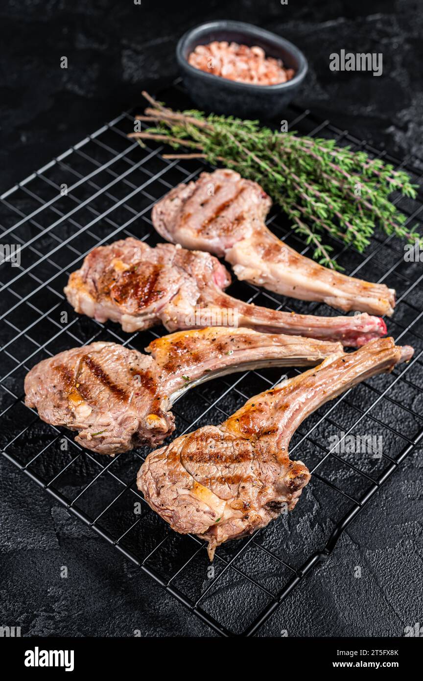 Barbecue Grilled lamb meat chops, mutton cutlets. Black background. Top ...
