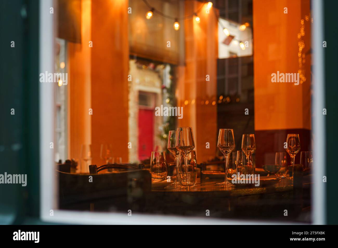 A restaurant table set for Christmas dinner is visible through the ...