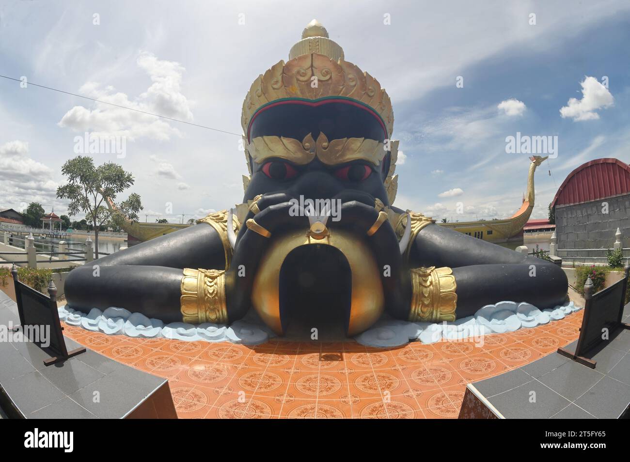 Outdoor statue of Phra Rahu suck the moon at Wat Sra Long Ruea temple ...