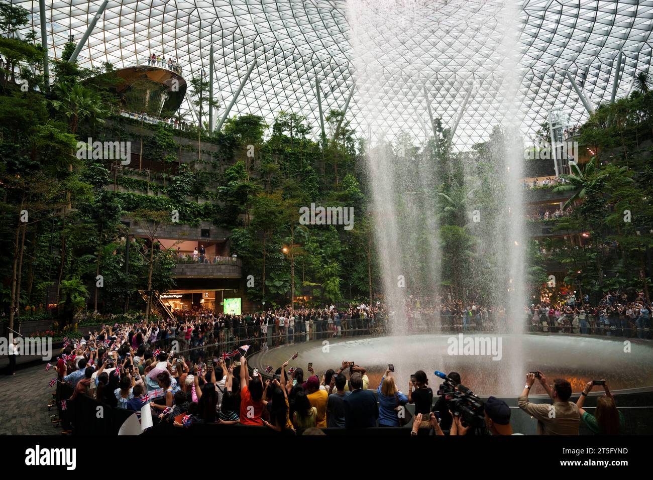 Britain's Prince William, left, stops at the rain vortex waterfall at ...