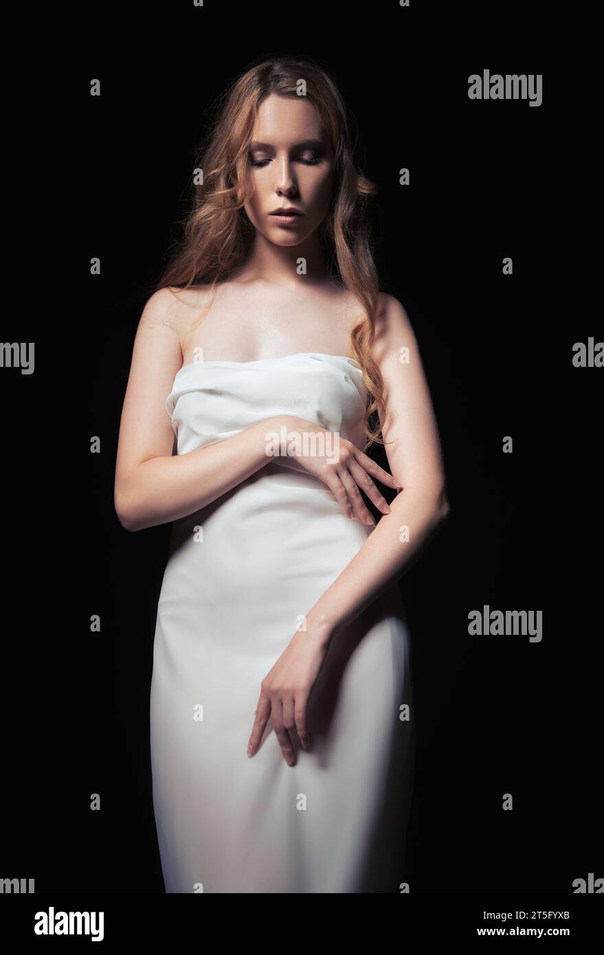 Gloomy portrait of the beautiful young sad girl against black ...