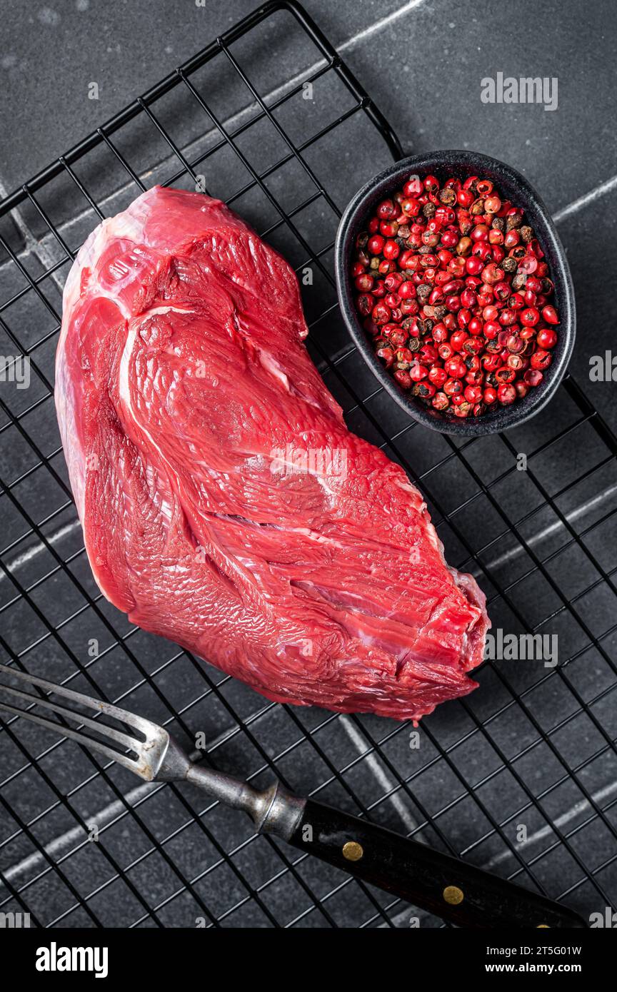 Raw beef meat piece for grilling with spices. Black background. Top ...