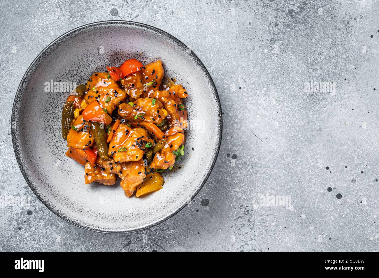 Chinese Sweet and Sour Pork guo bao rou in a bowl. Gray background. Top ...