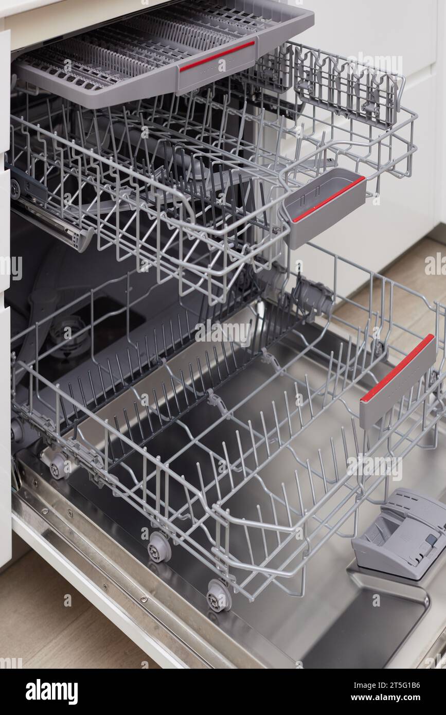 Modern built-in empty dishwasher with open door in the kitchen Stock ...