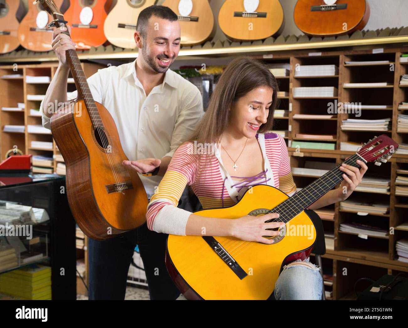 Smiling guitarist girl playing guitar Stock Photo - Alamy