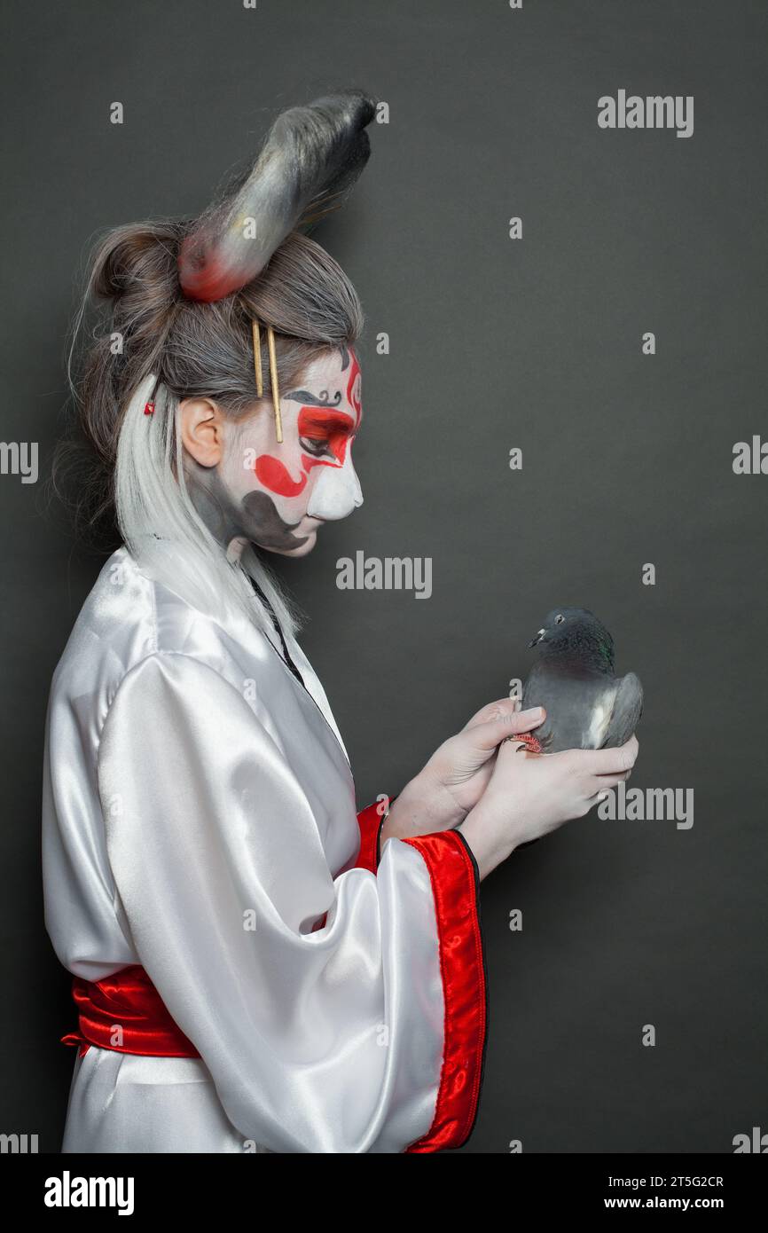 Attractive female model woman with makeup wearing mask and stage ...