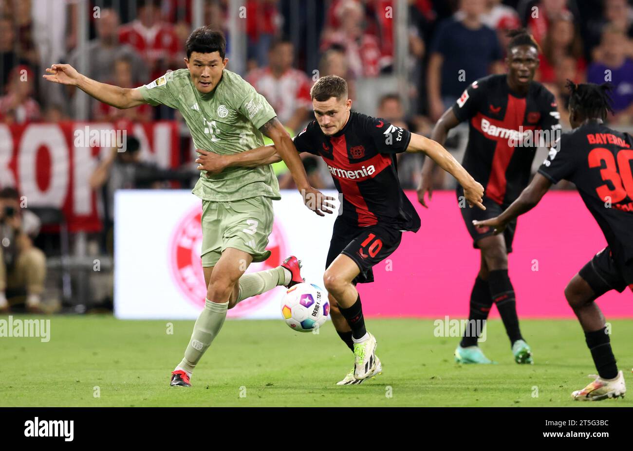 Min Jae Kim of FC Bayern Muenchen Florian Wirtz of Bayer Leverkusen FC ...