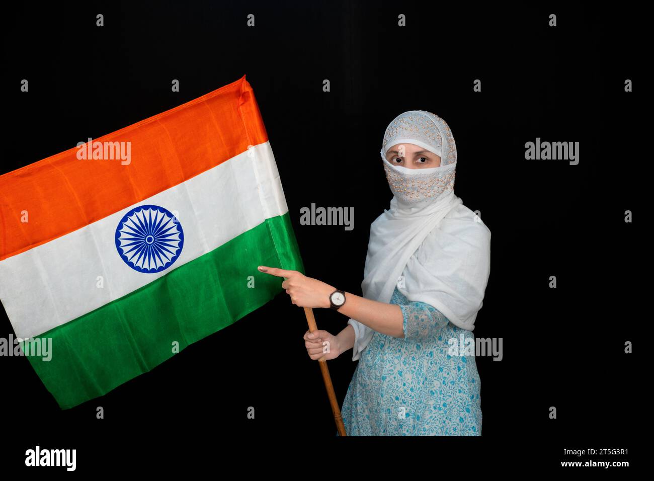 Young Indian woman holding tricolor Indian National Flag, Shows Inked ...