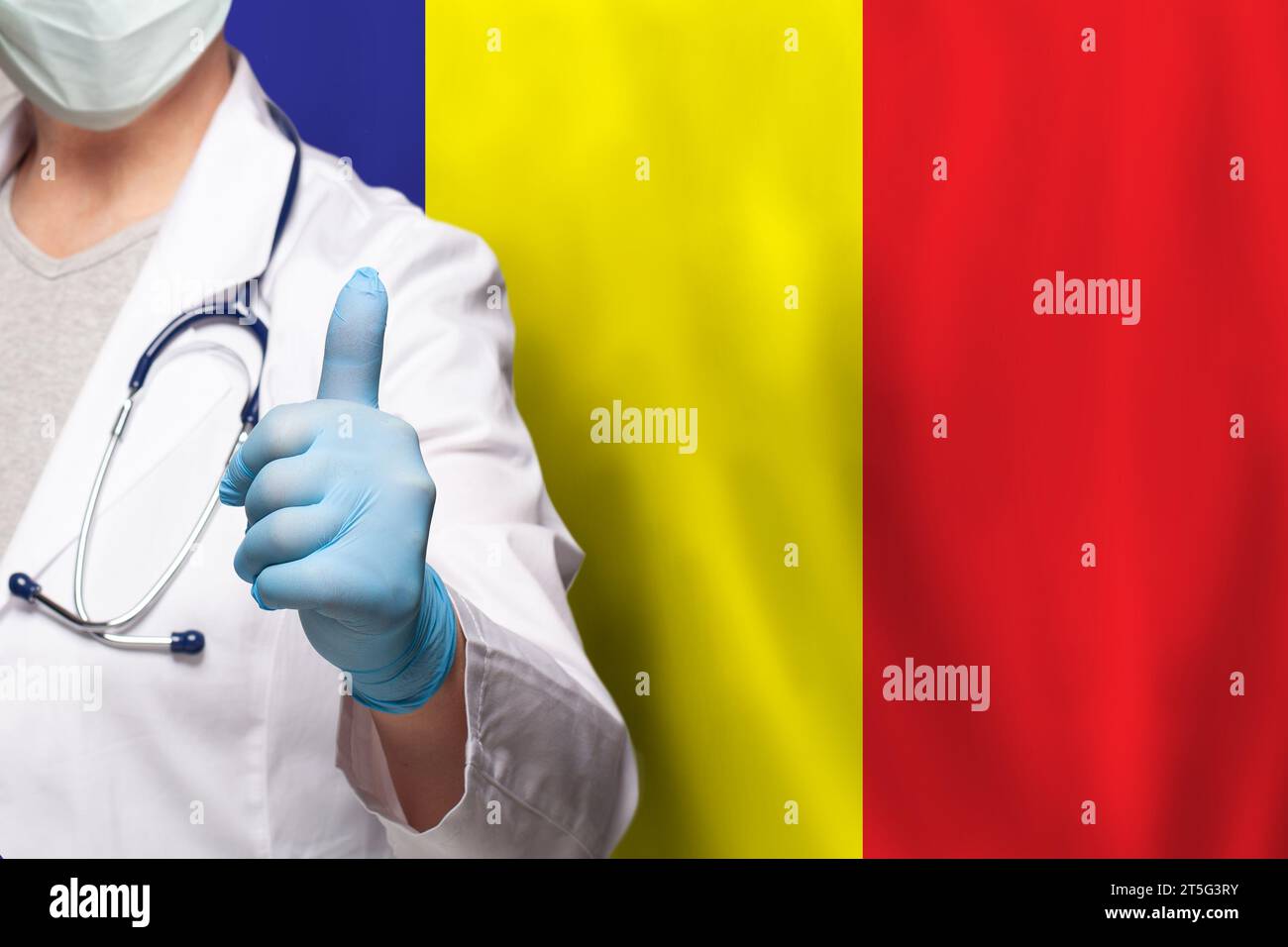 Romanian doctor's hand showing thumb up positive gesture on flag of ...