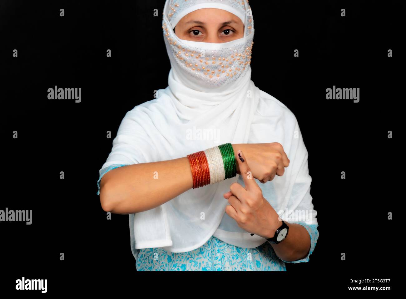 A Young Indian Woman With An Inked Finger Shows Bangles In The Colors ...