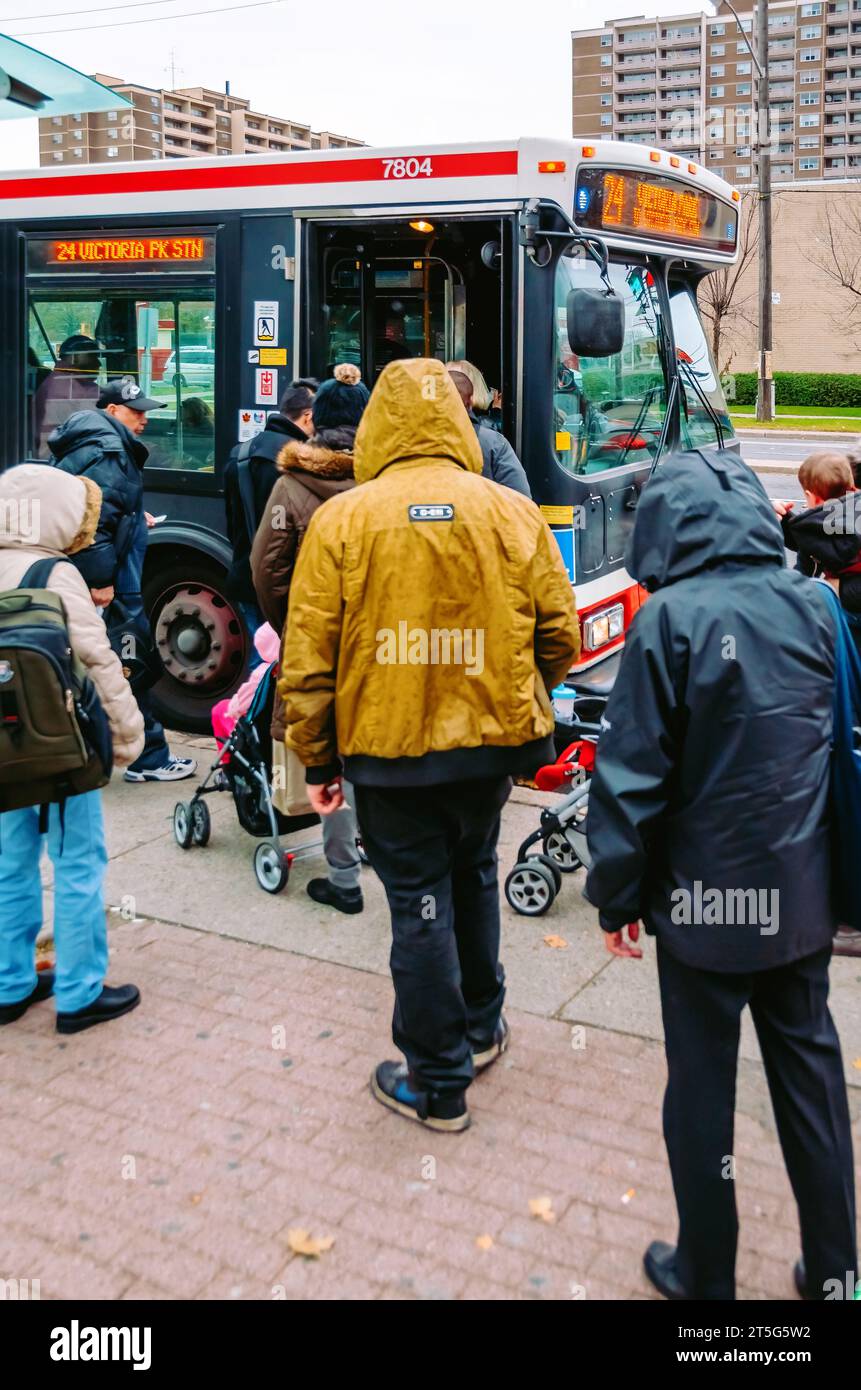 Toronto, Canada, 2013, People getting on a TTC bus. The vehicle runs ...