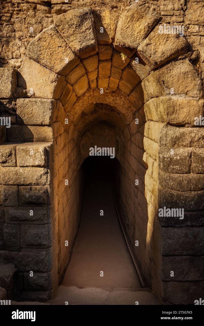 Paved arched passageway and tunnel door leading to a dungeon entrance ...