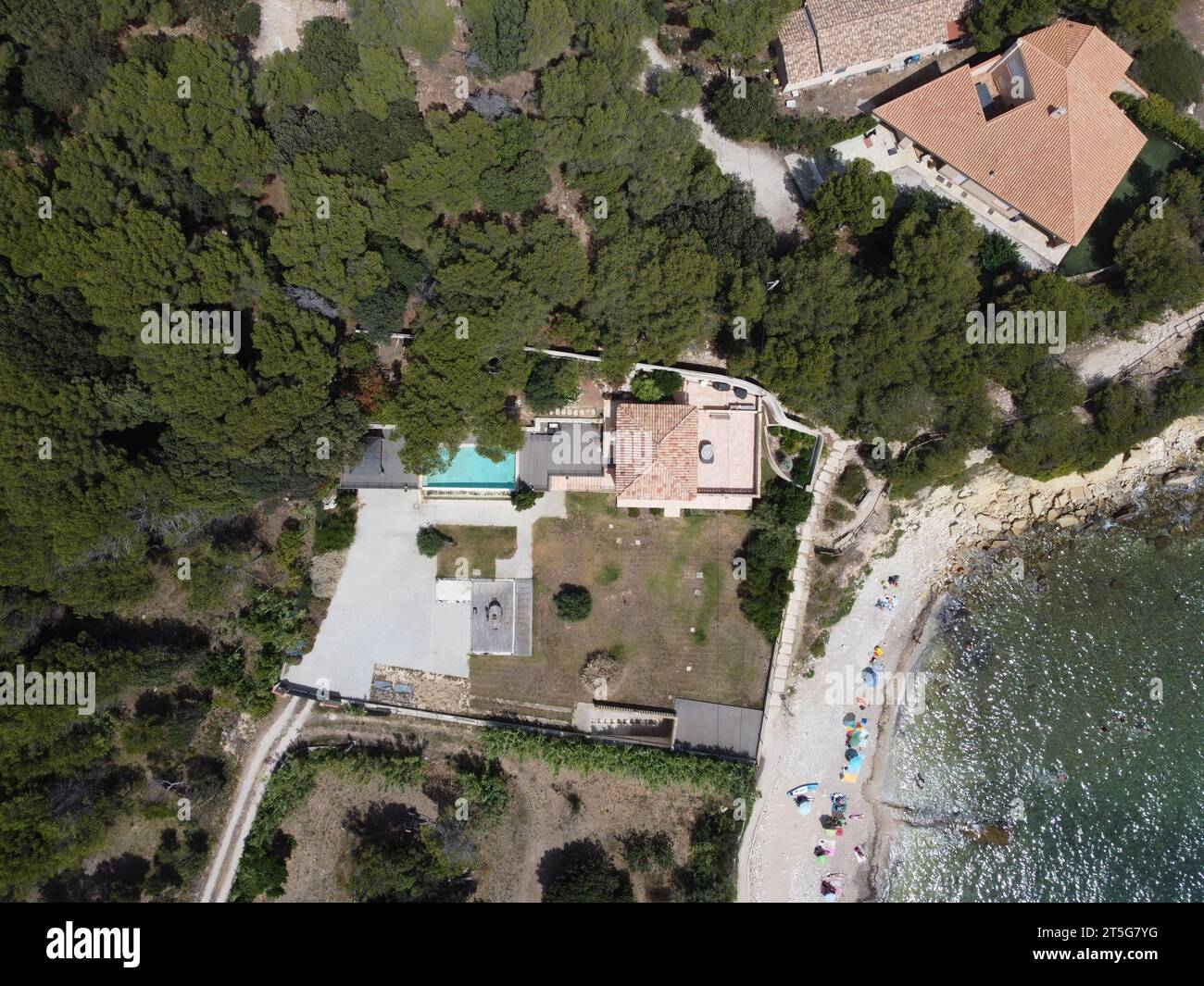 Bird's eye aerial view of a secluded villa with a swimming pool nestled ...