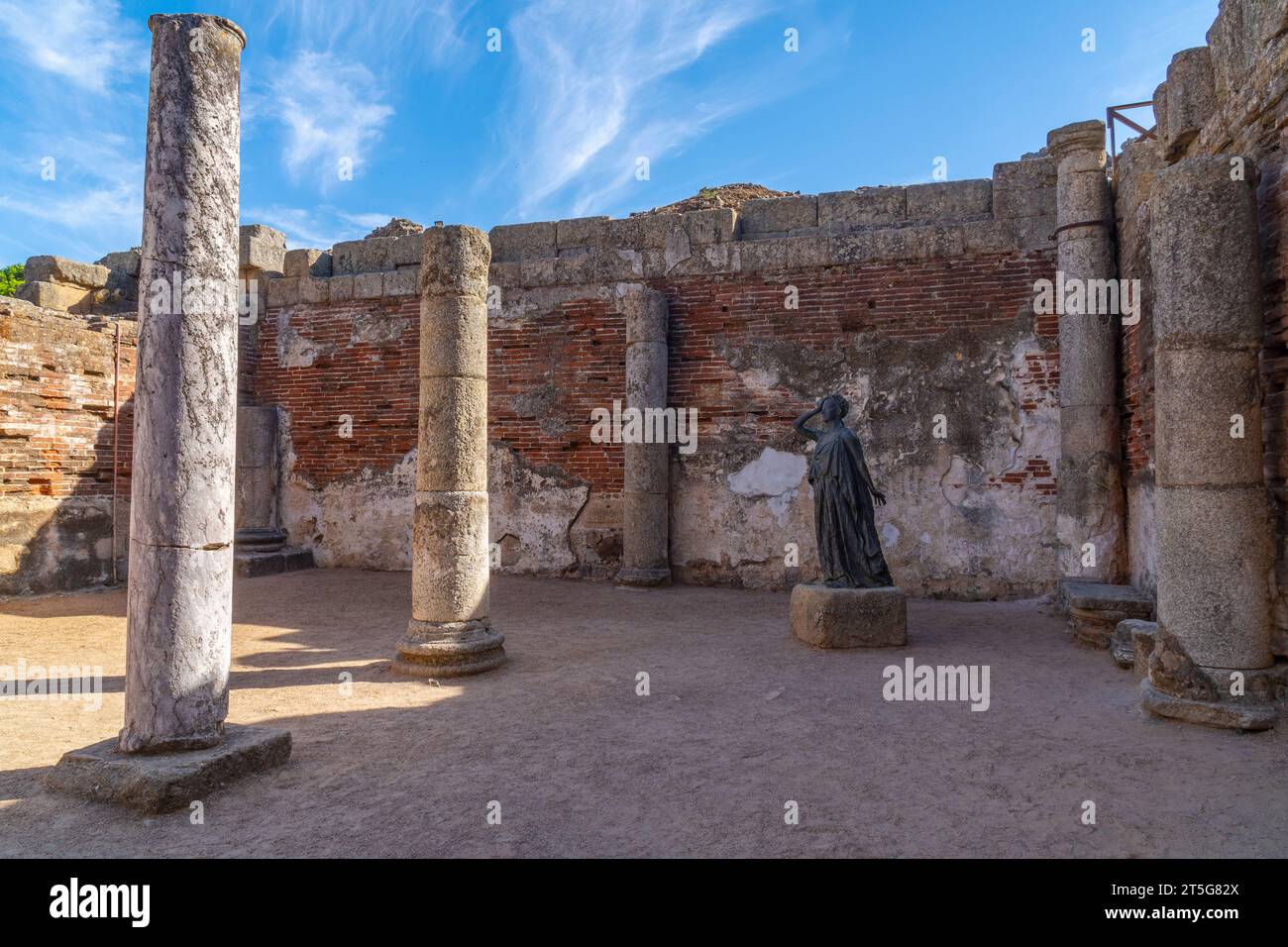 Ruins of a Roman hall with columns and the bronze statue of the actress ...