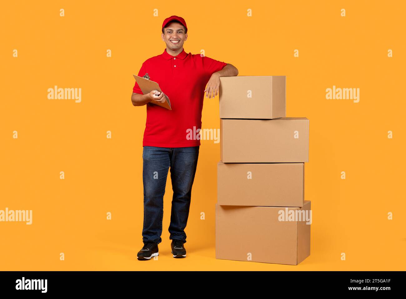 delivery man leaning on cardboard parcels boxes stack in studio Stock ...