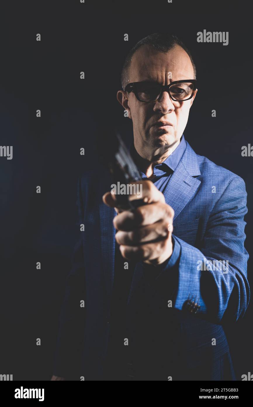 Assasin spy killer with handgun pistol in elegant suit and shirt book ...