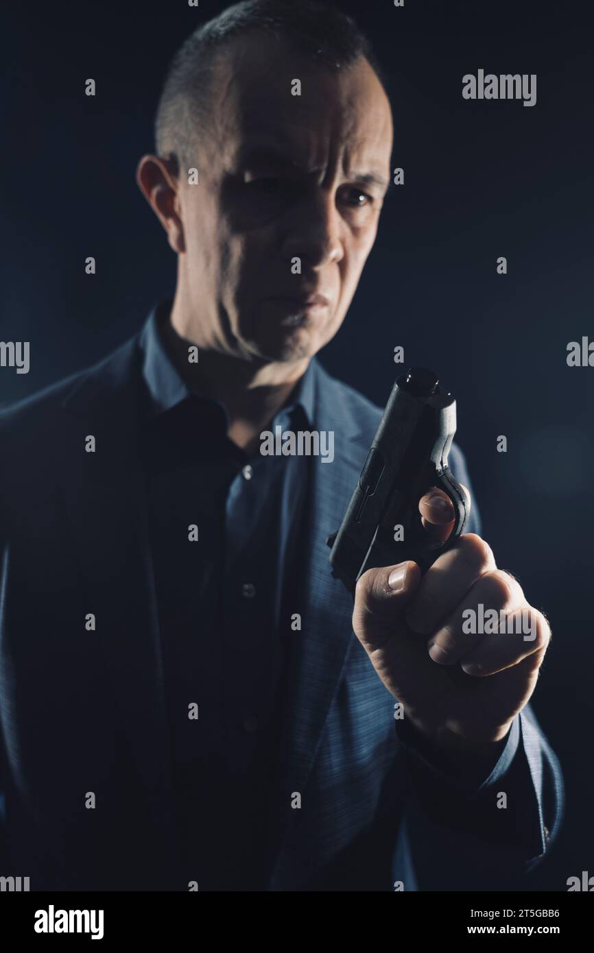 Assasin spy killer with handgun pistol in elegant suit and shirt book ...