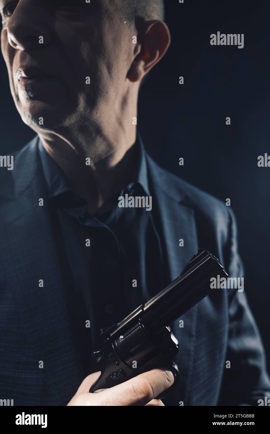 Assasin spy killer with handgun pistol in elegant suit and shirt book ...