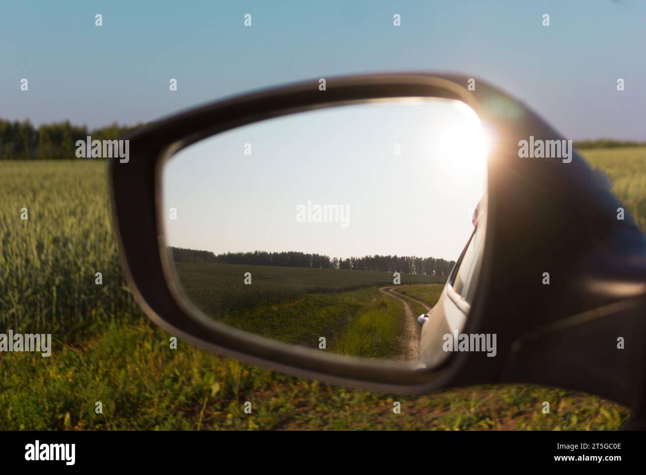 Side mirror of a car. Reflecting sun and fields Stock Photo - Alamy