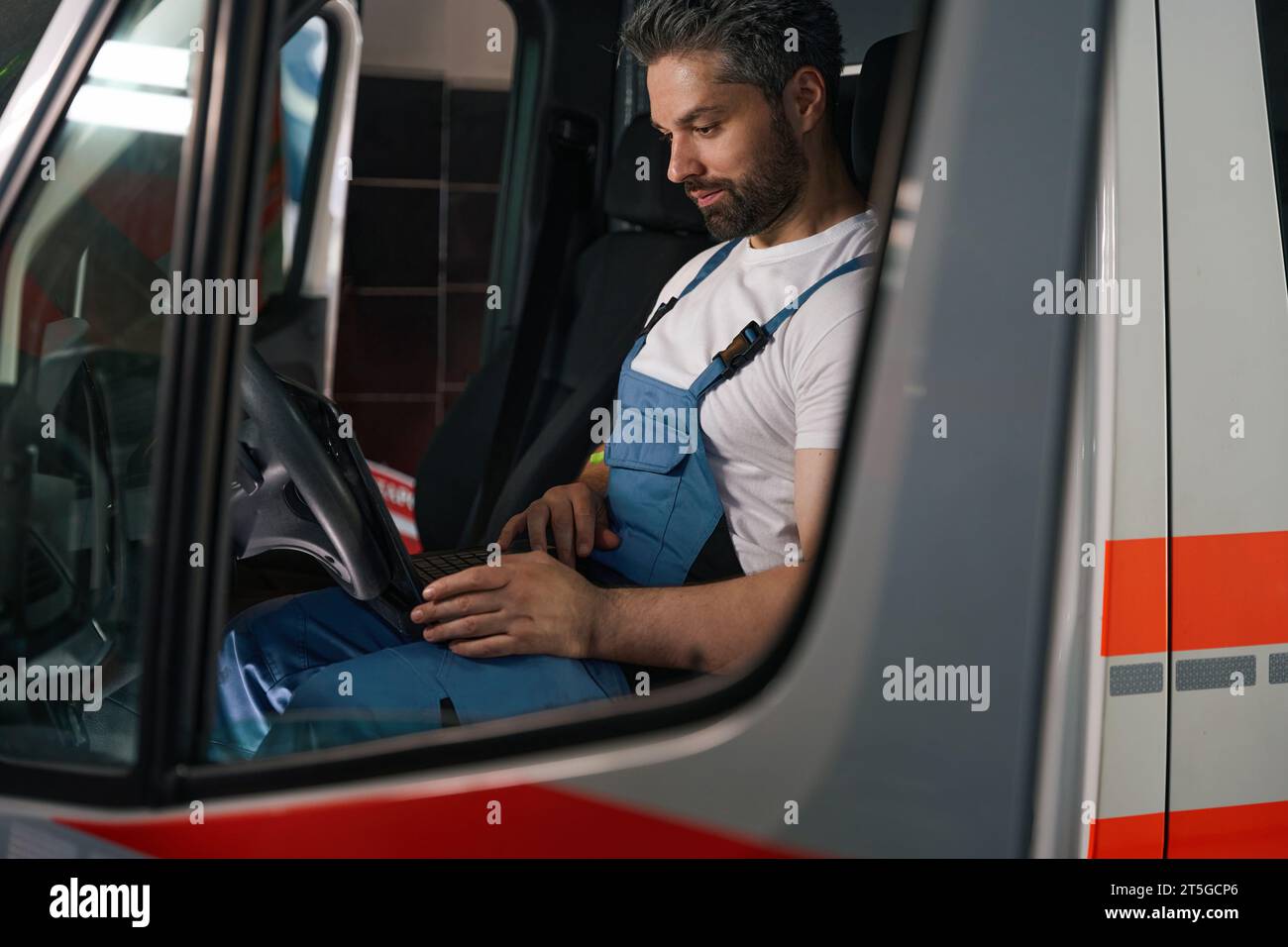 Automotive technician performing computer diagnostic test on client ...