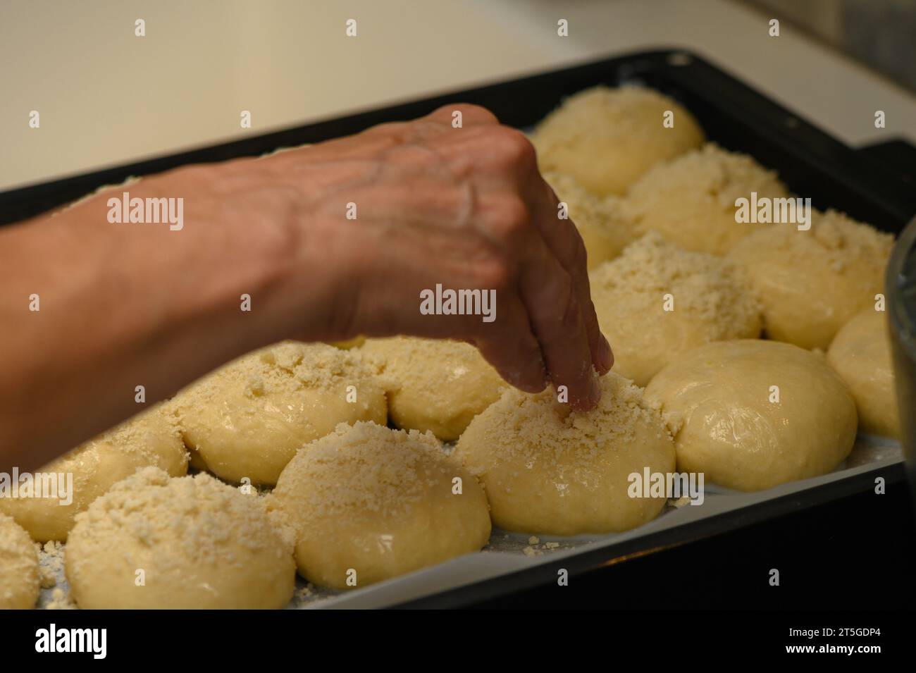 woman sprinkles buns in the kitchen 5 Stock Photo - Alamy