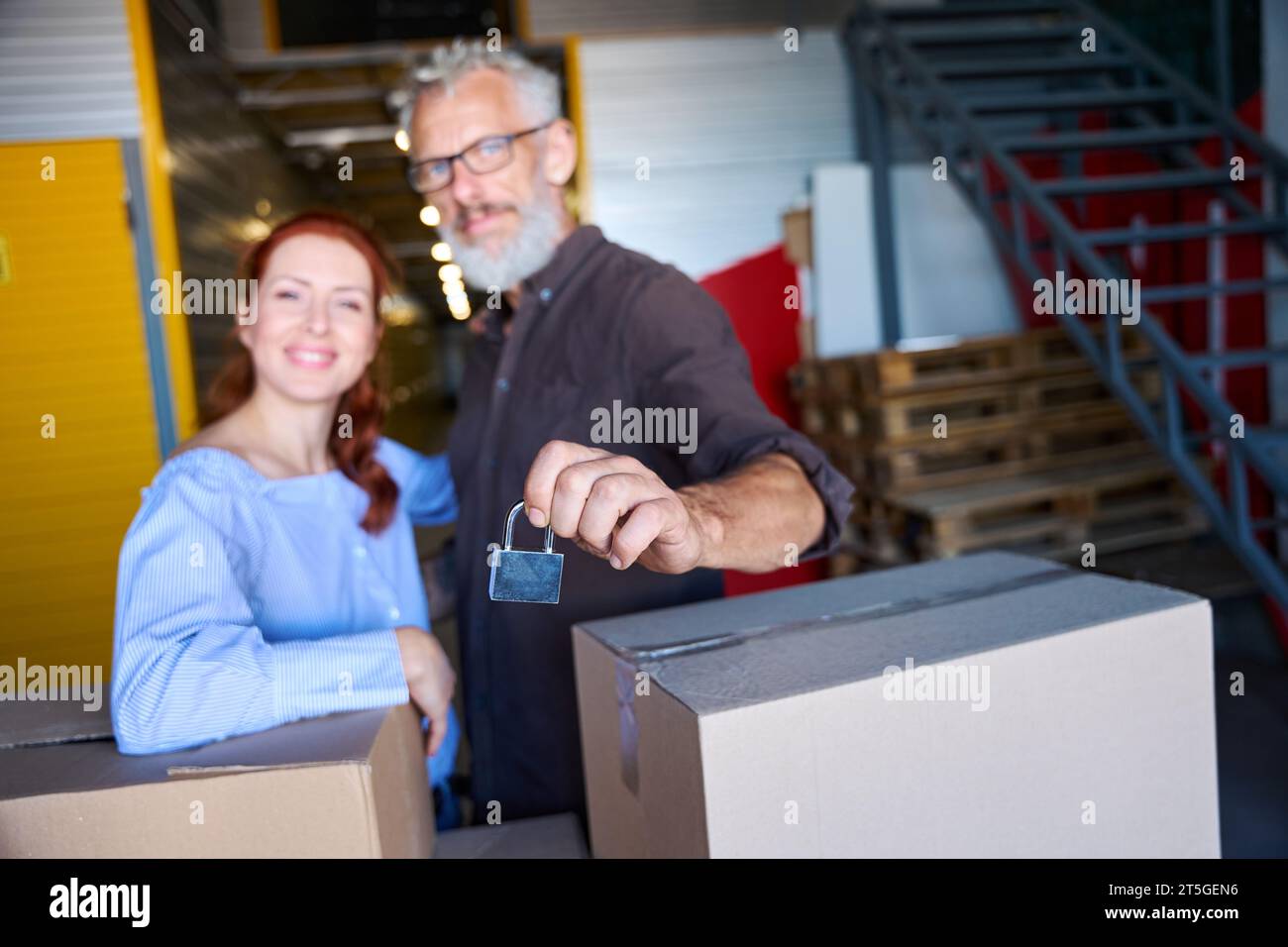People stand near boxes with things in a warehouse Stock Photo - Alamy
