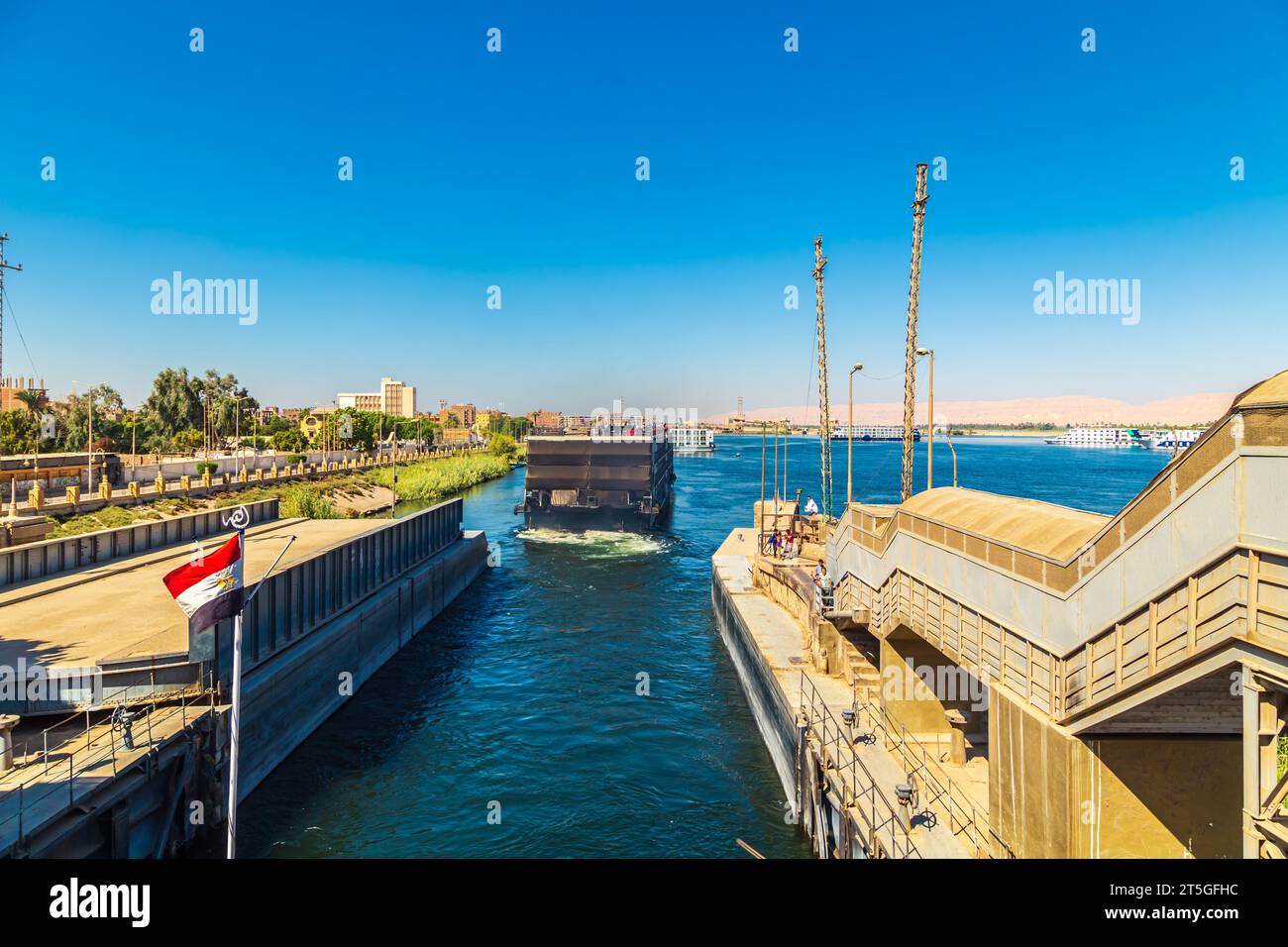 Cruise ships pass through the Esna lock. Water gate on the Nile River ...